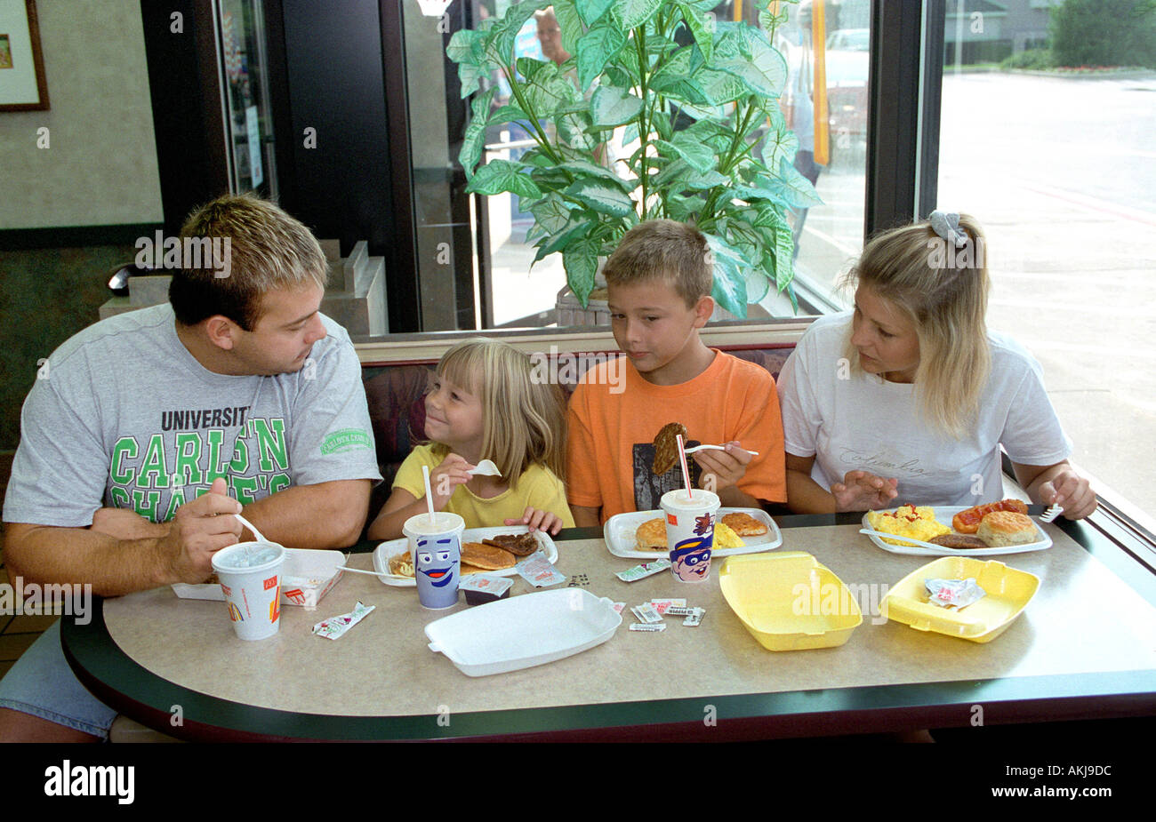 Family eats fast food and McDonald s fast food restaurant using plastic ...