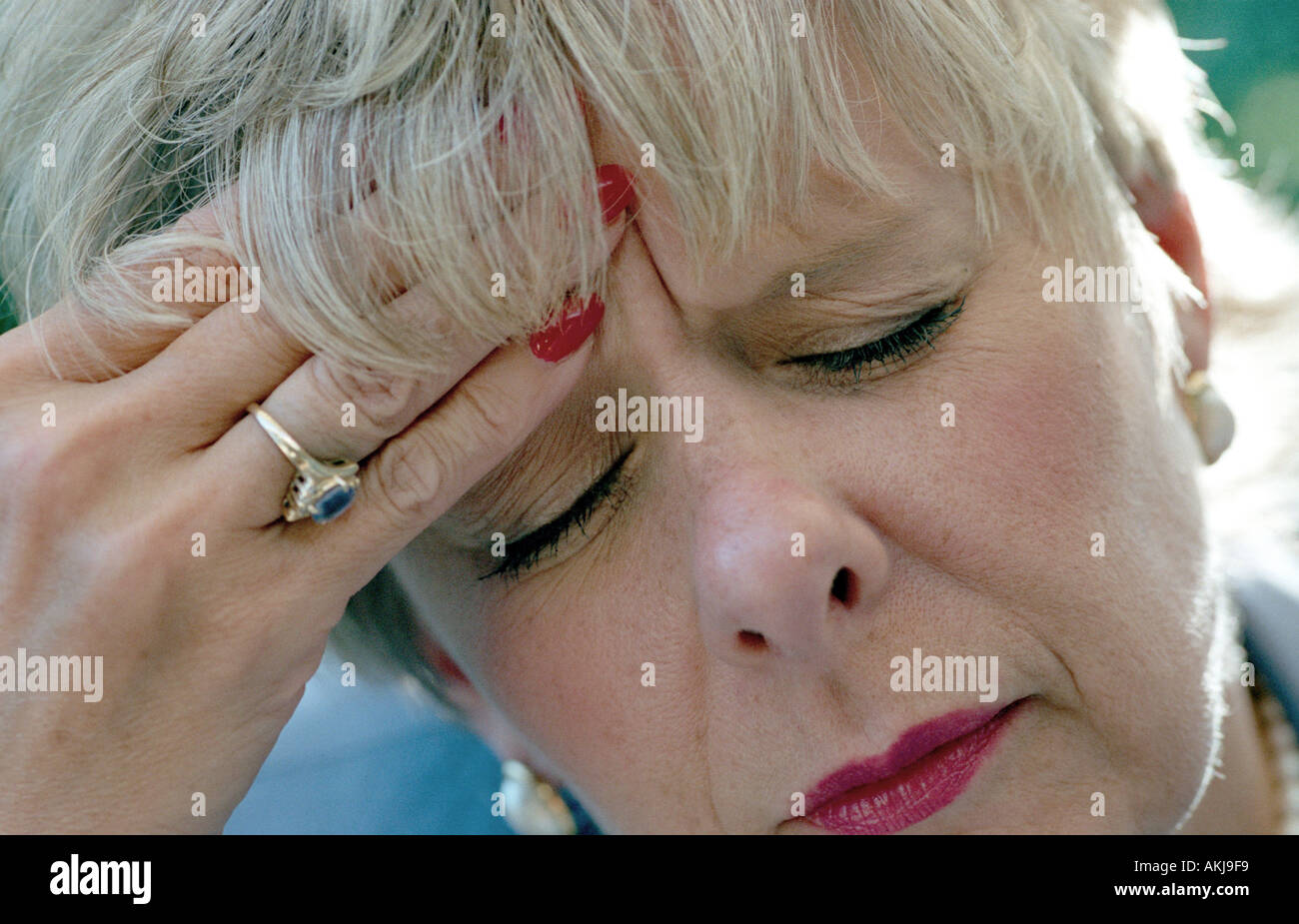 female exhibits symptoms of anguish headaches stress Stock Photo - Alamy
