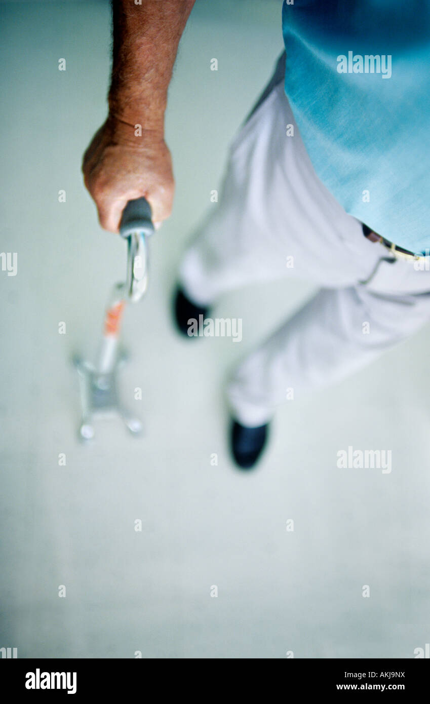Man using a quad cane Stock Photo - Alamy