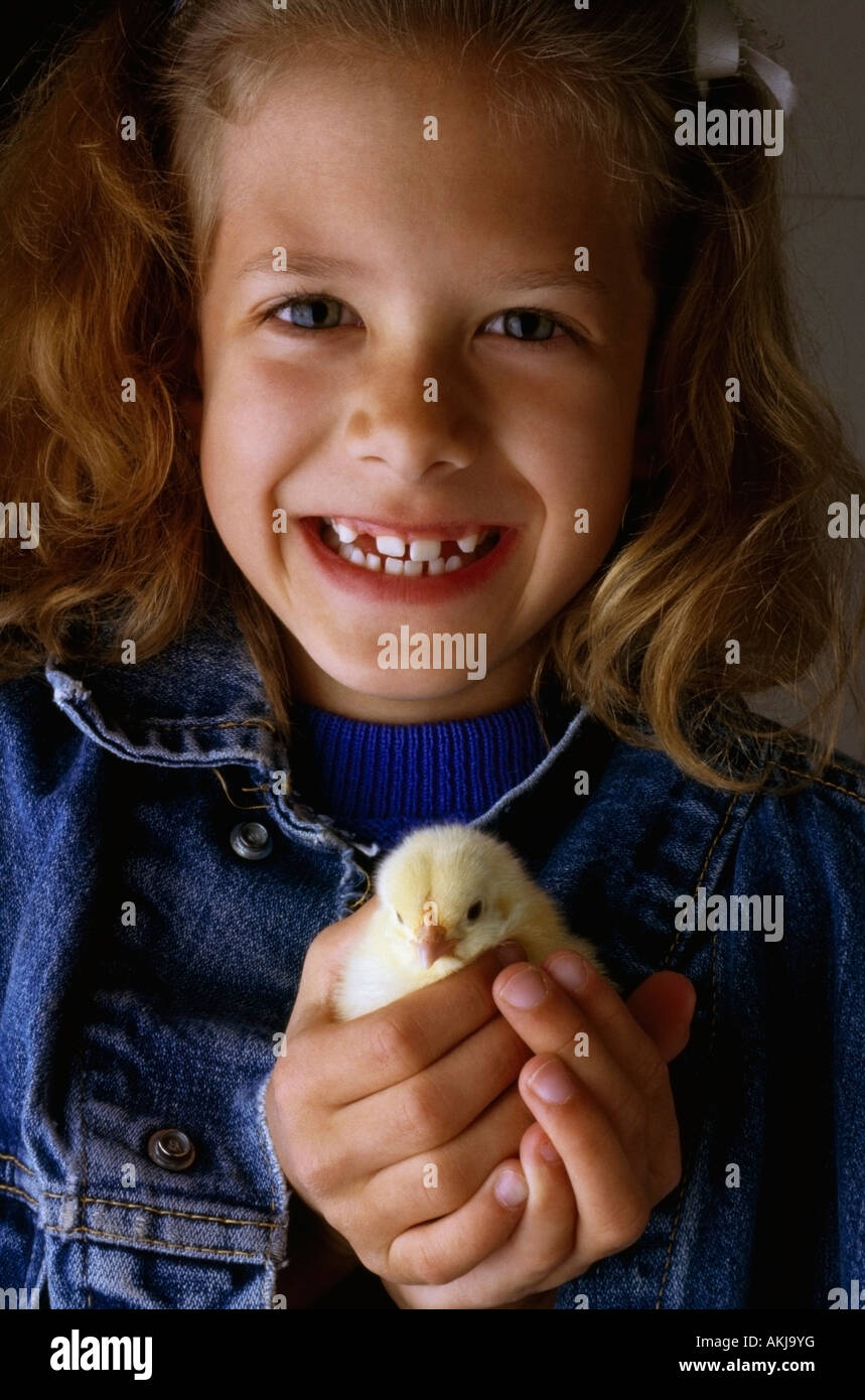 A girl holding a baby chick Stock Photo - Alamy