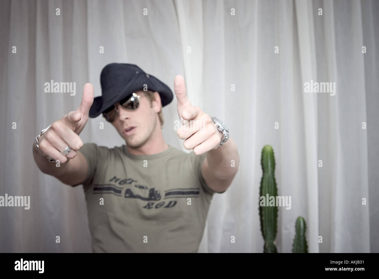 Urban cowboy with green hot rod shirt Stock Photo - Alamy