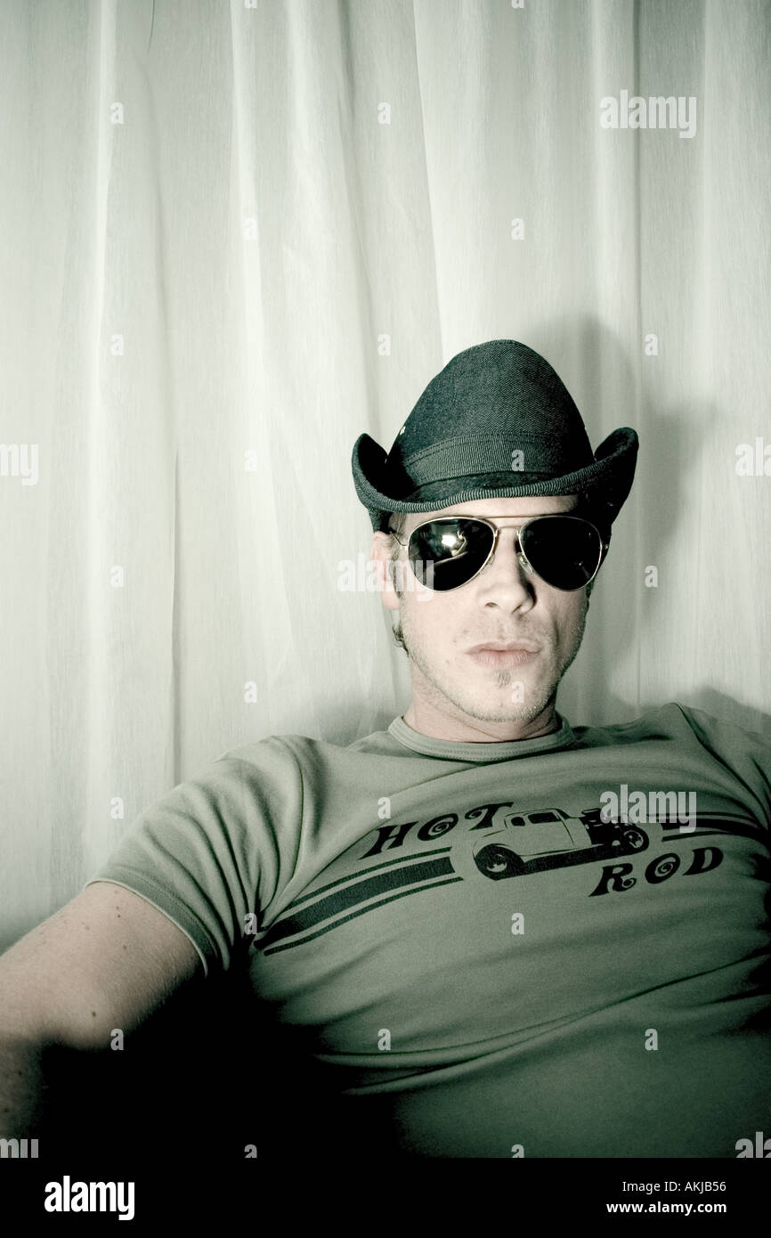 Urban cowboy with green hot rod shirt looking really Stock Photo - Alamy