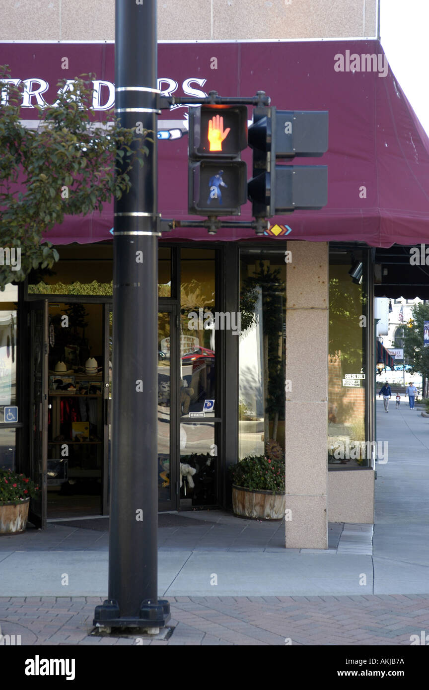 Sign on traffic light pole directing pedestrians to walk or wait or ...