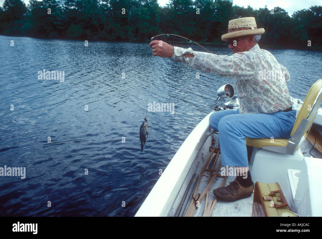 Man Fishing from Boat Stock Photo - Alamy