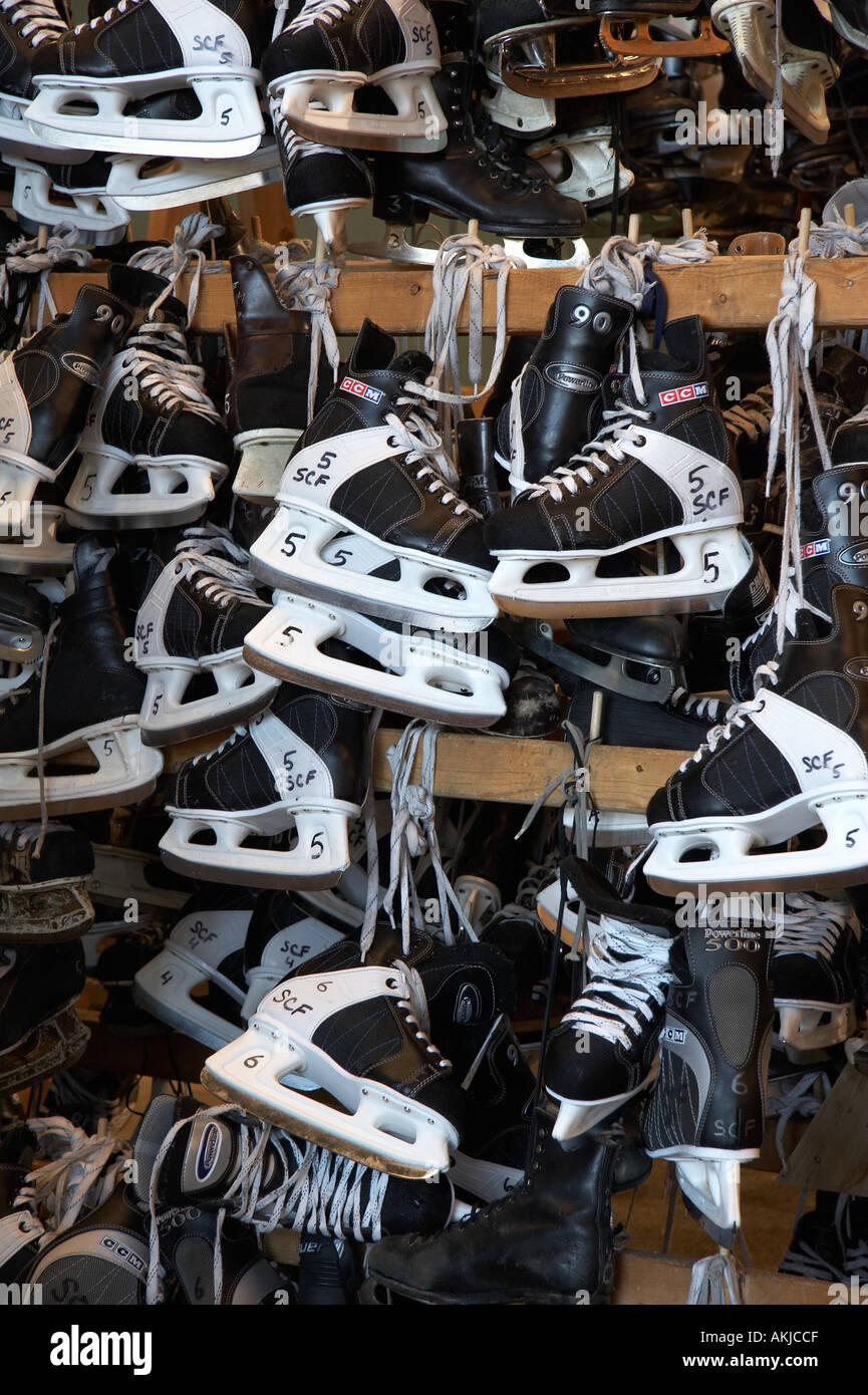 Ice skates hanging on rack at ice skating rink Stock Photo - Alamy