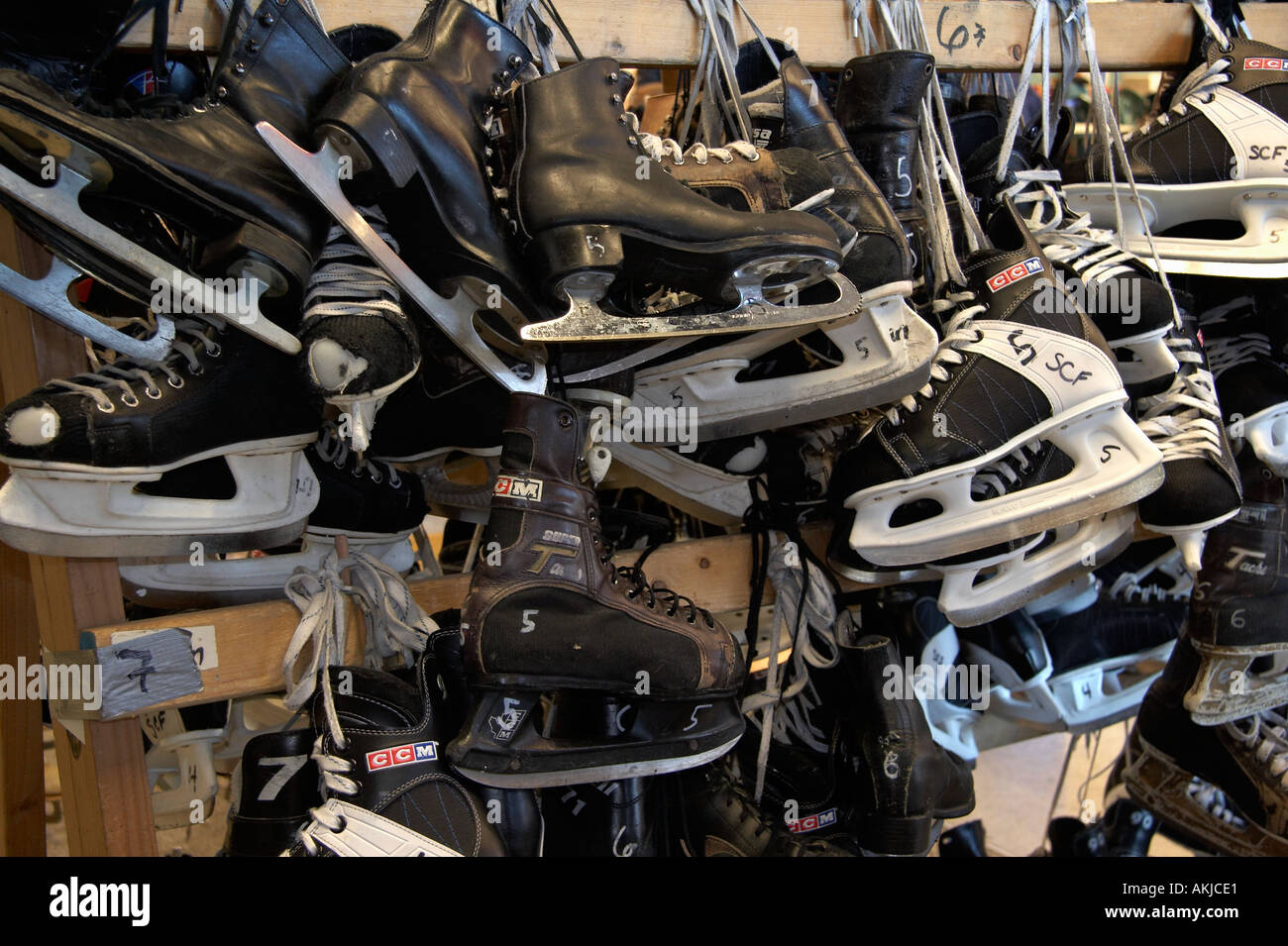 Ice skates hanging on rack at ice skating rink Stock Photo - Alamy