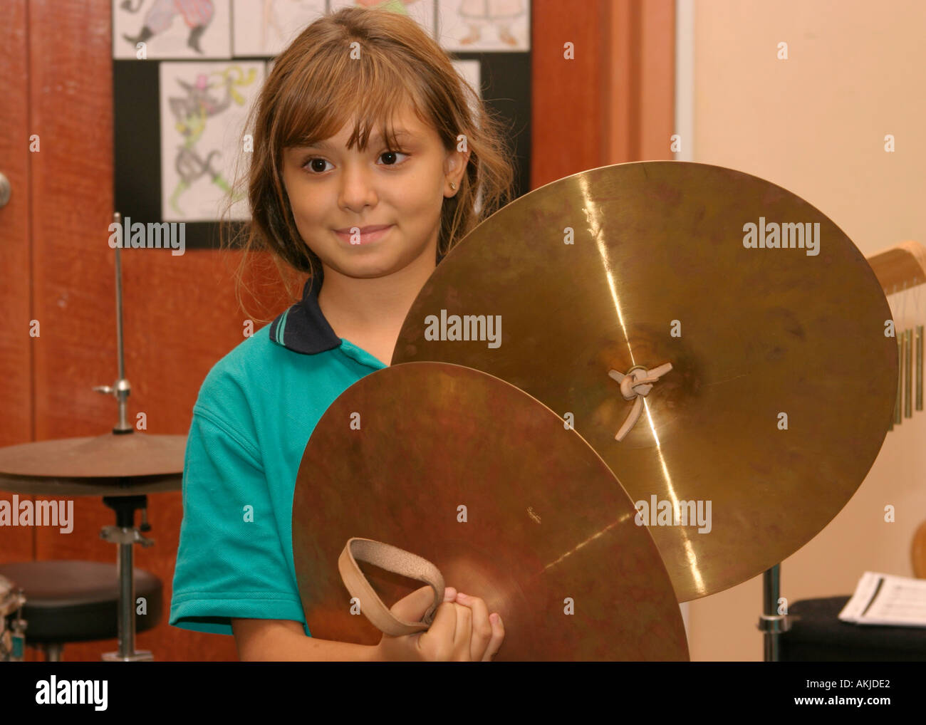 young school girl playing cymbals Stock Photo - Alamy