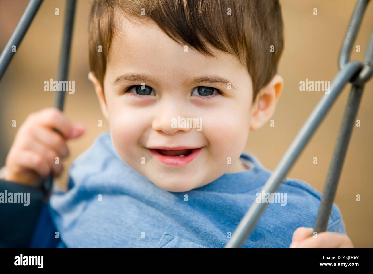 Portrait of a boy swinging Stock Photo - Alamy