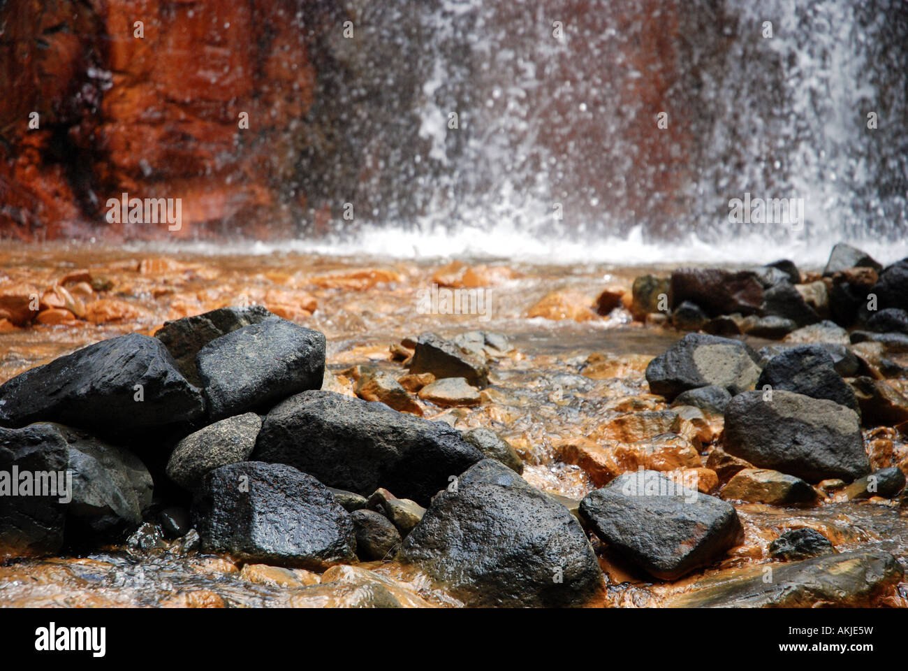 Colorful waterfall with rocks painted red because of the iron in the ...