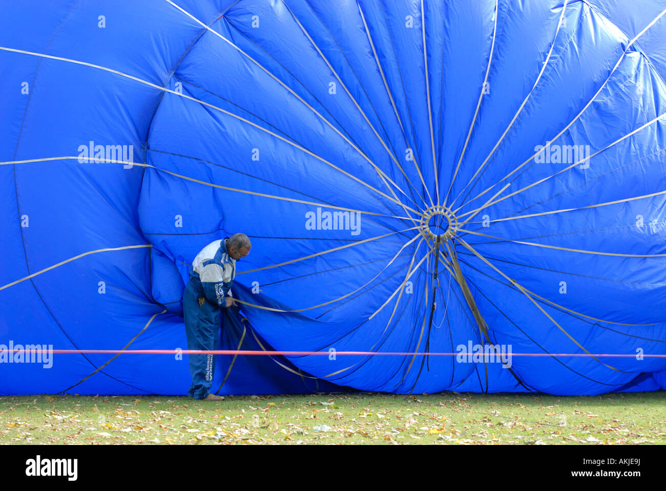 Inflating a blue hot air balloon Stock Photo - Alamy