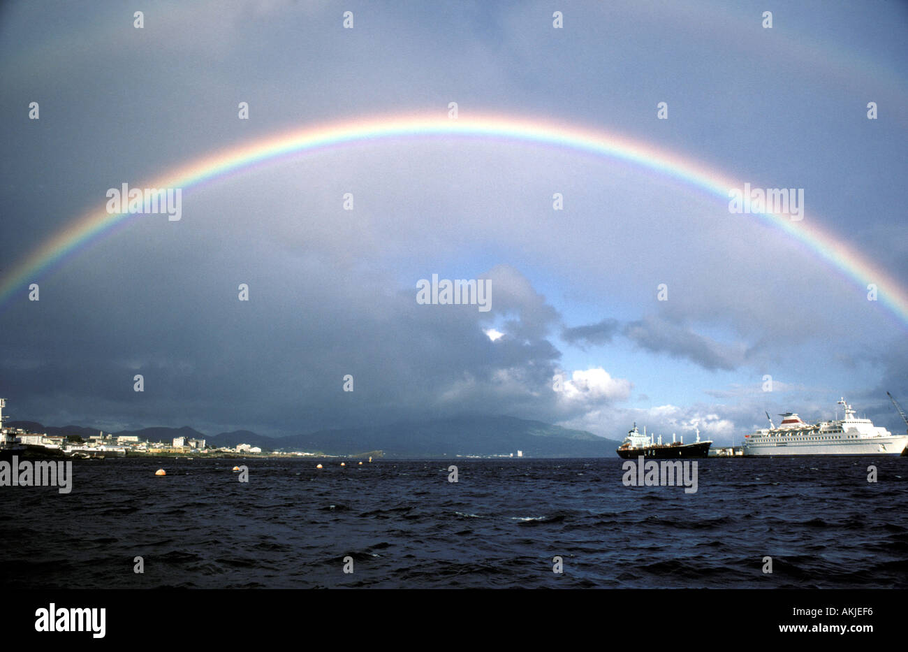 A bright rainbow lights up the sky outside the port and over the bay at ...