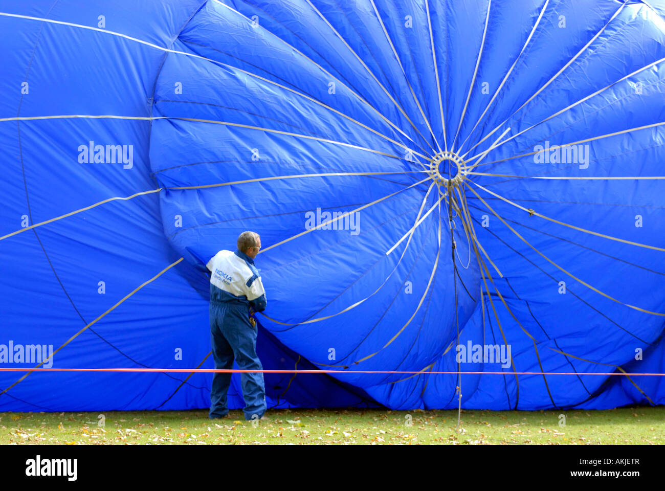 Inflating a blue hot air balloon Stock Photo - Alamy