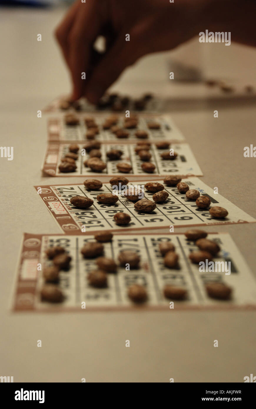 A player places a marker on one of his five bingo cards Stock Photo - Alamy