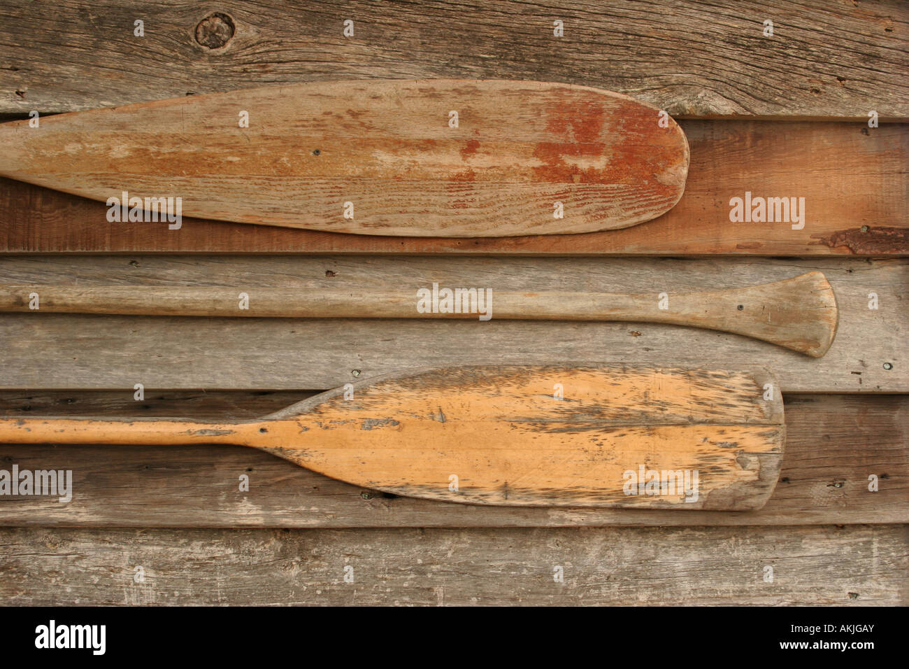 Three wooden paddles hanging on wood siding Stock Photo - Alamy