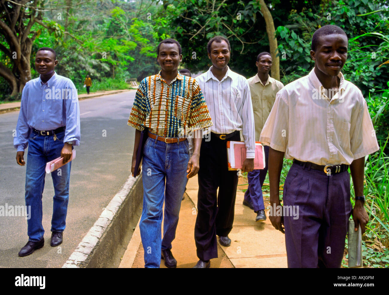 A group of male students walk on the campus of Cape Coast University ...