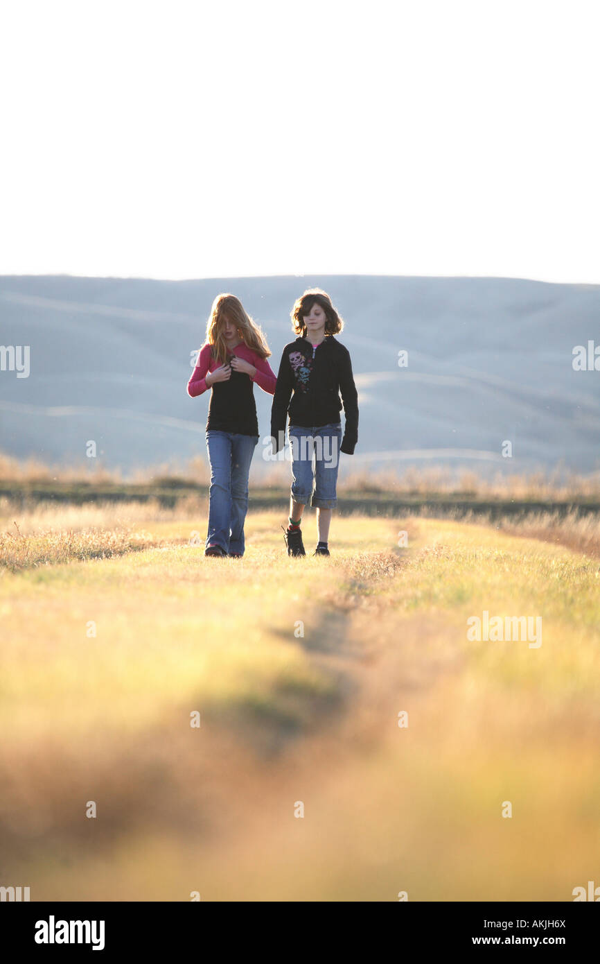 Two girls walking along causeway in scenic Saskatchewan Stock Photo - Alamy