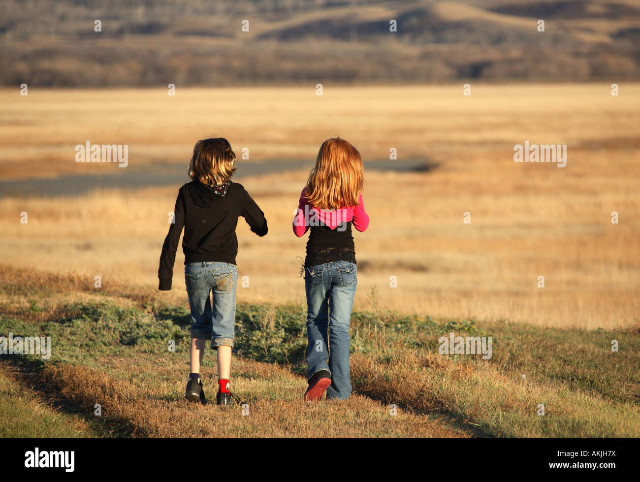 Two girls walking along causeway in scenic Saskatchewan Stock Photo - Alamy