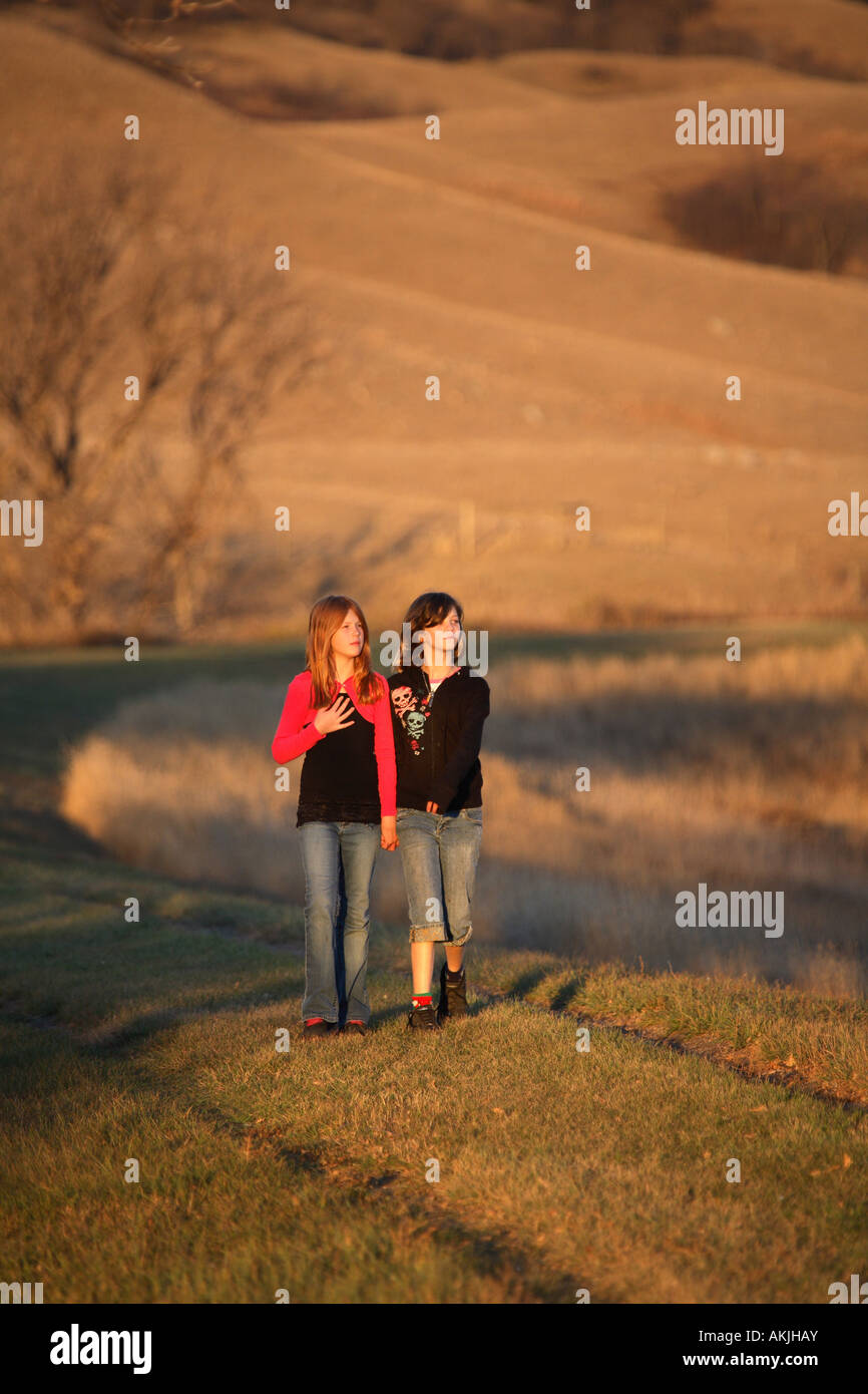 Two girls walking along causeway in scenic Saskatchewan Stock Photo - Alamy