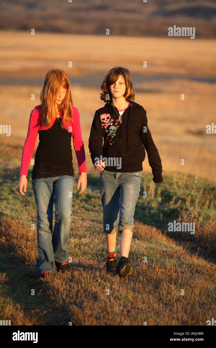 Two girls walking along causeway in scenic Saskatchewan Stock Photo - Alamy
