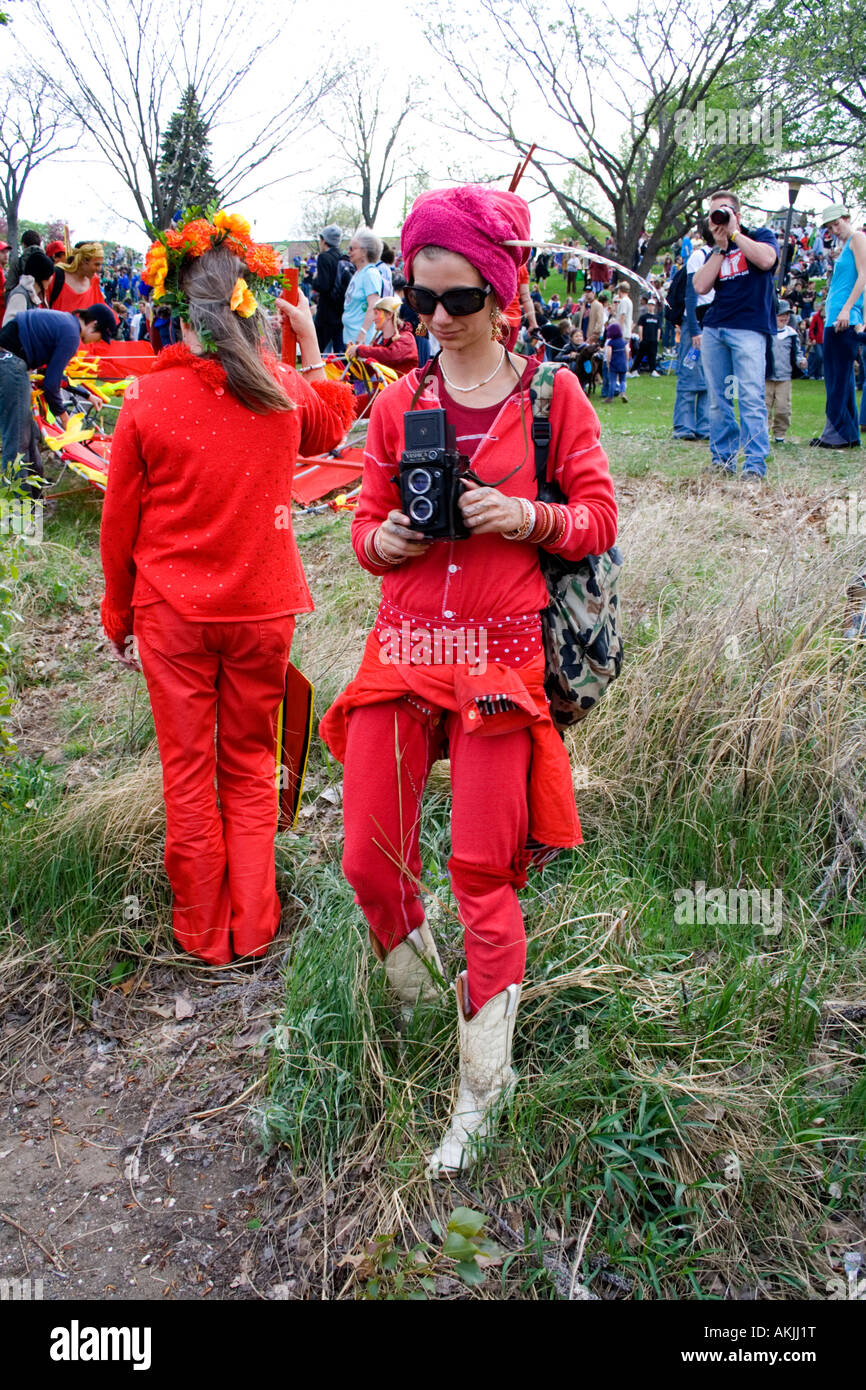 Woman photographing with Yashica twin-lens reflex camera. MayDay Parade ...