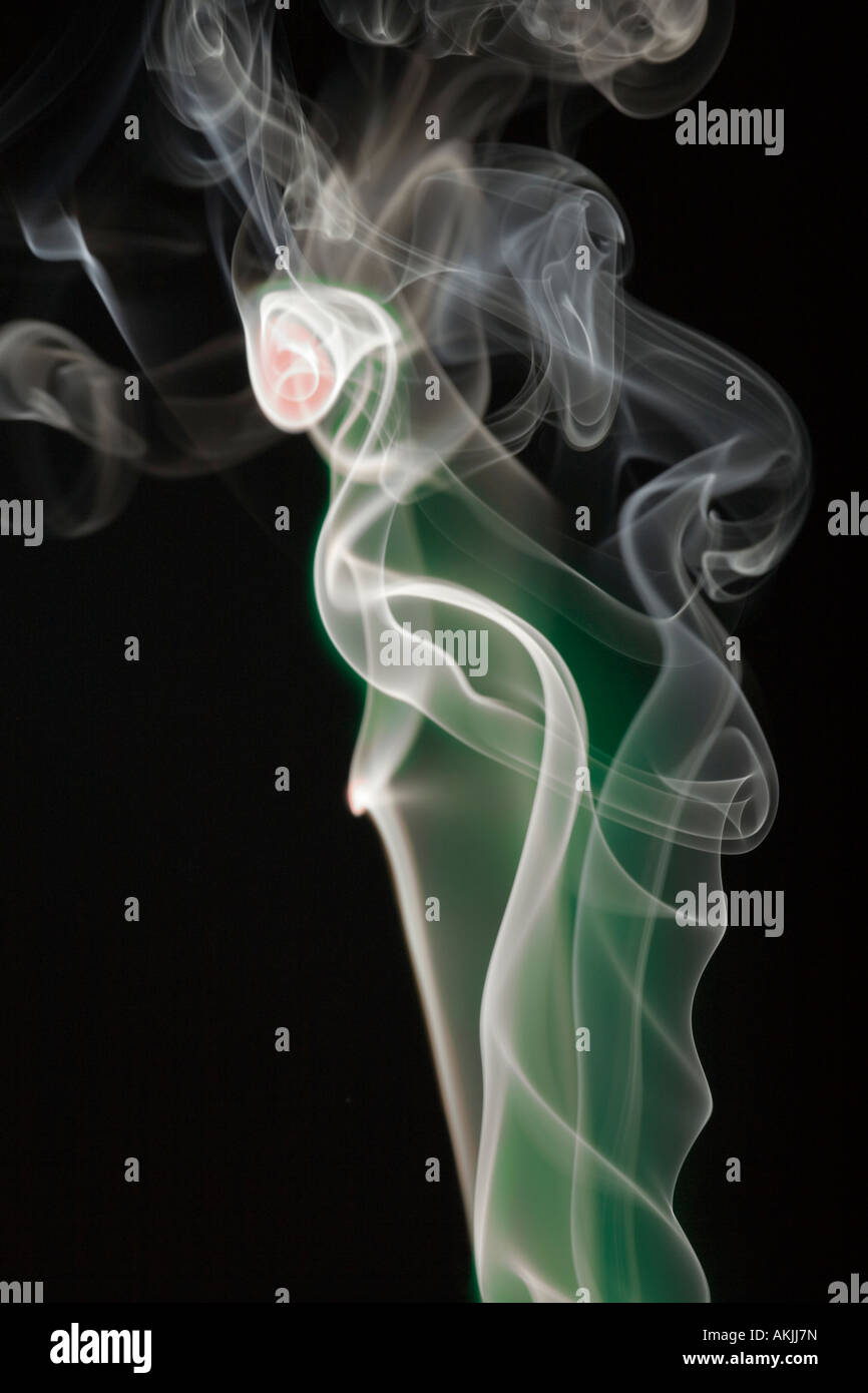 Drifting smoke forming the appearance of a ghostly lady in a cloak with ...