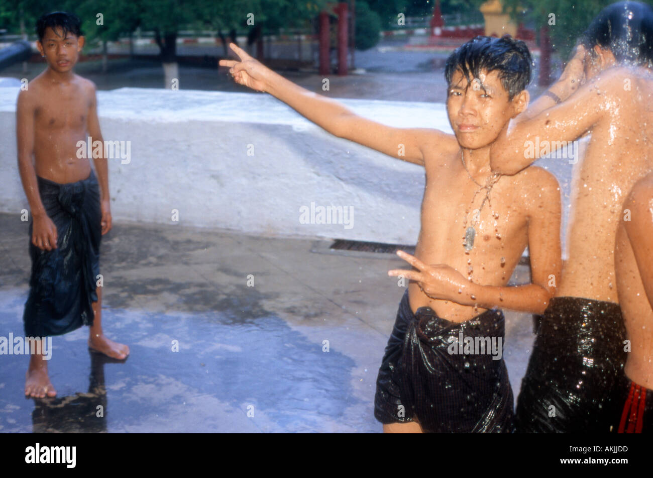 Boys in the rain Mandalay Myanmar Burma Stock Photo - Alamy