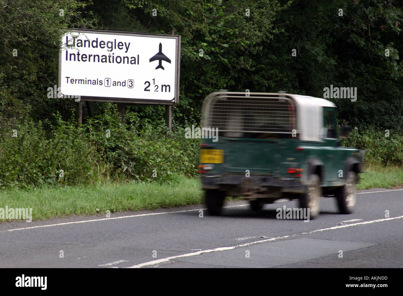 landrover driving past a spoof road sign indicating that small welsh ...