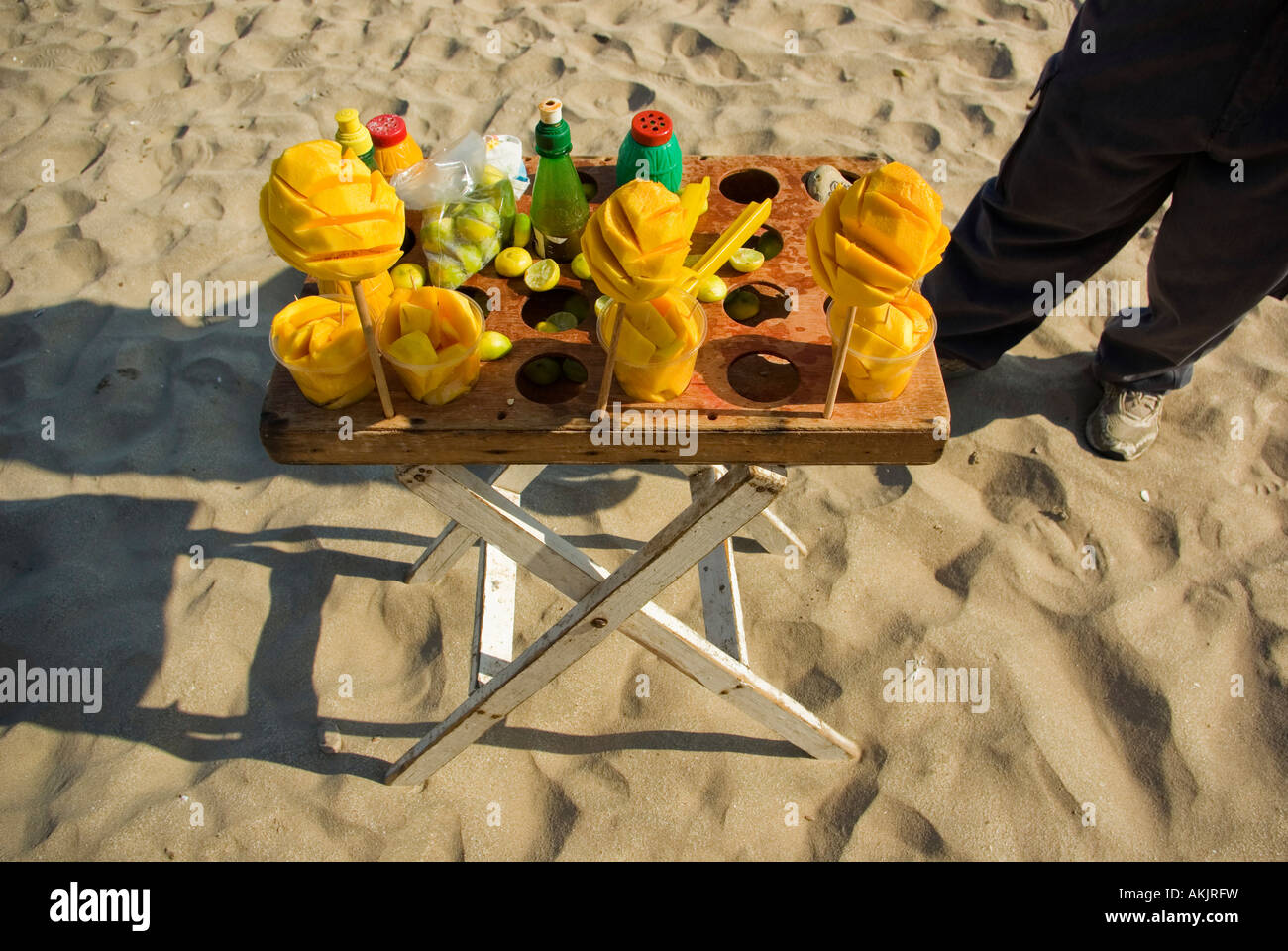 mango seller on sandy beach Stock Photo - Alamy