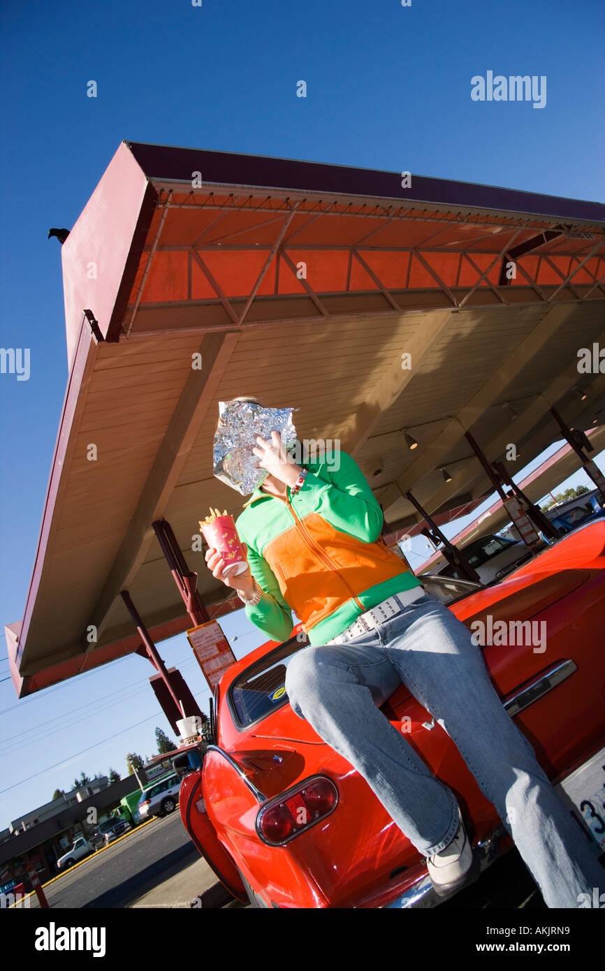 Woman pigging out at drive in restaurant Stock Photo - Alamy
