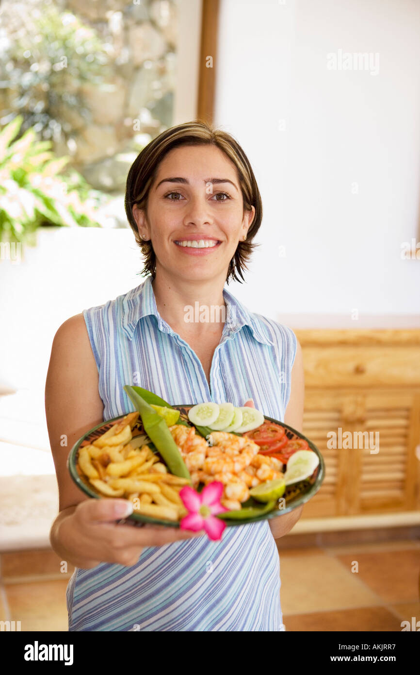 Woman with platter of food Stock Photo - Alamy
