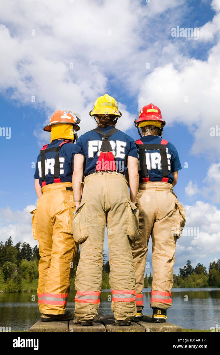 Three female firefighters viewed from behind Stock Photo - Alamy