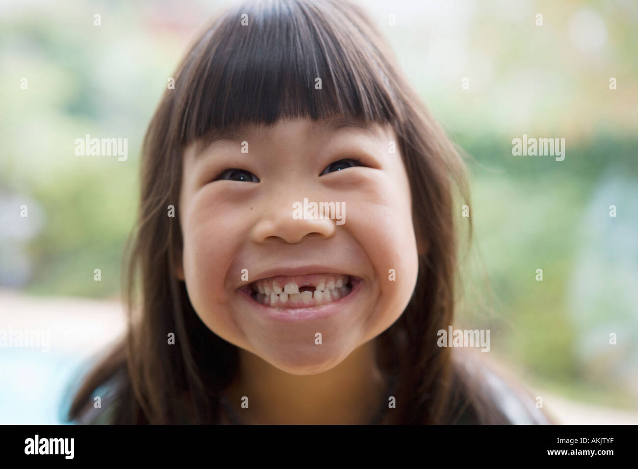 Grinning girl with missing tooth Stock Photo - Alamy