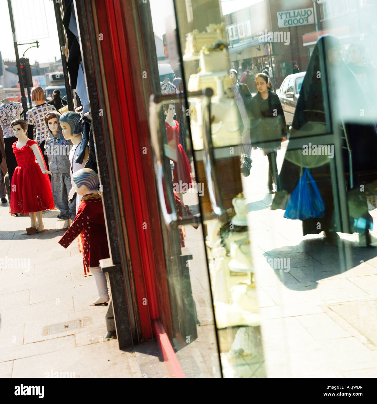 reflection in shop window of woman in full Burkah high street retail ...
