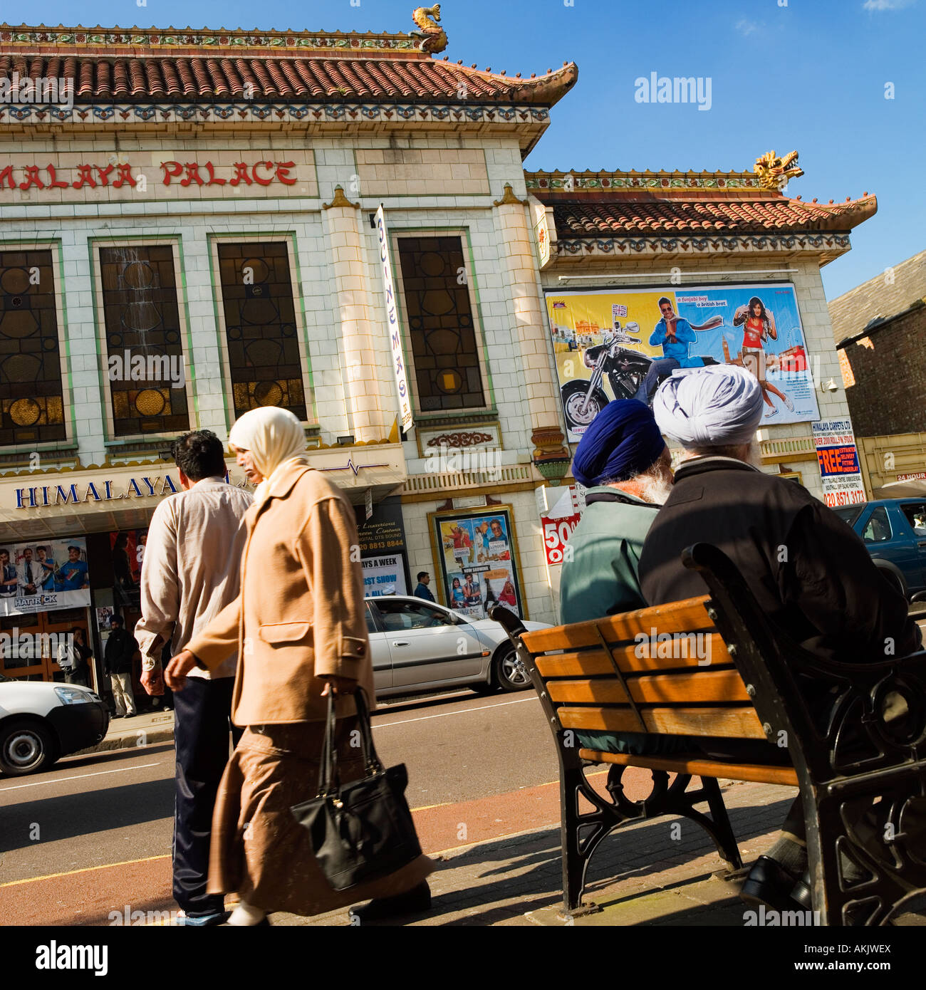 multicultural London pedestrians and Sikh men relaxing opposite ...
