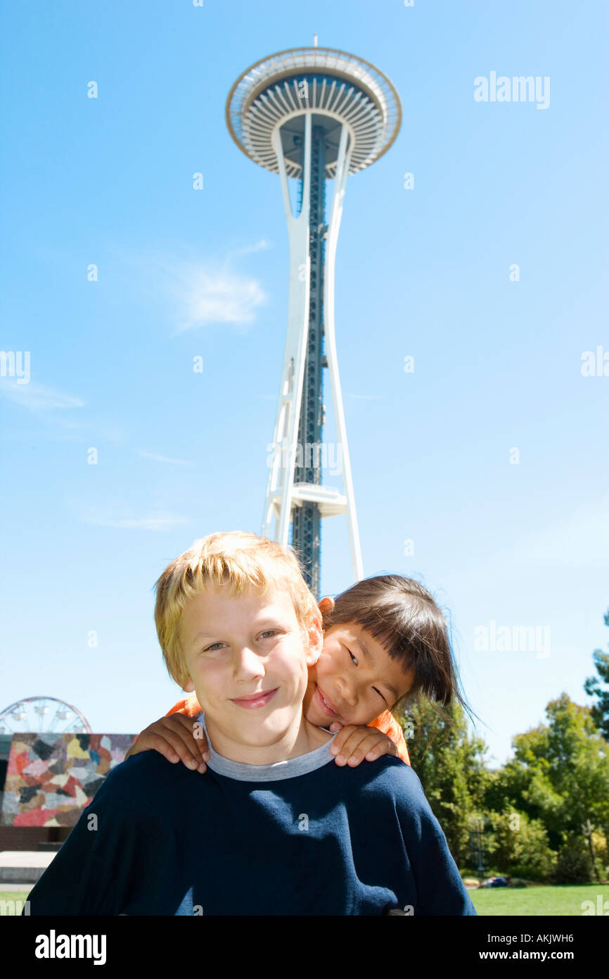 Boy and girl posing with space needle Stock Photo - Alamy
