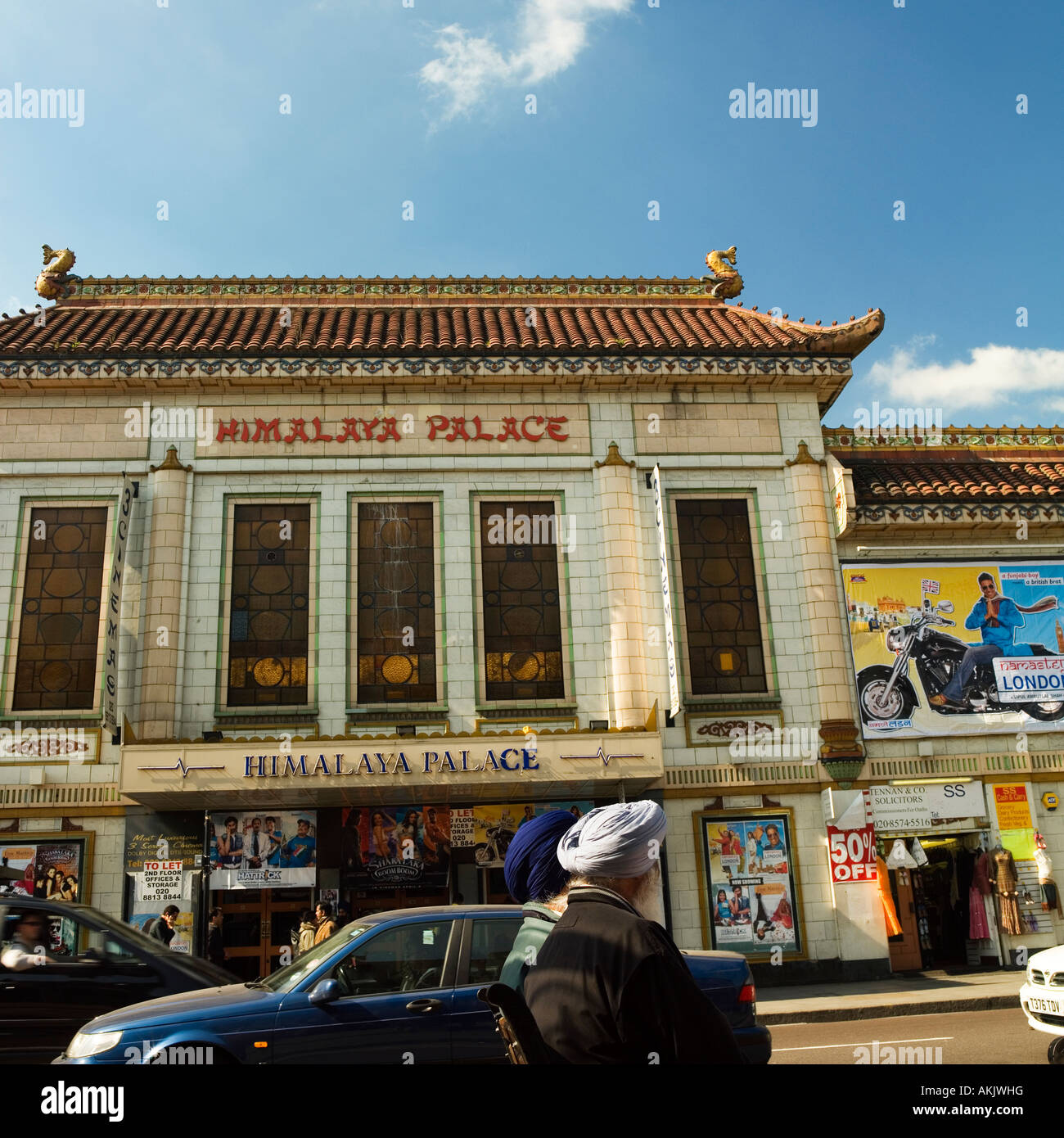 two sikh men sit outside Himalaya Palace cinema Southall London no ...