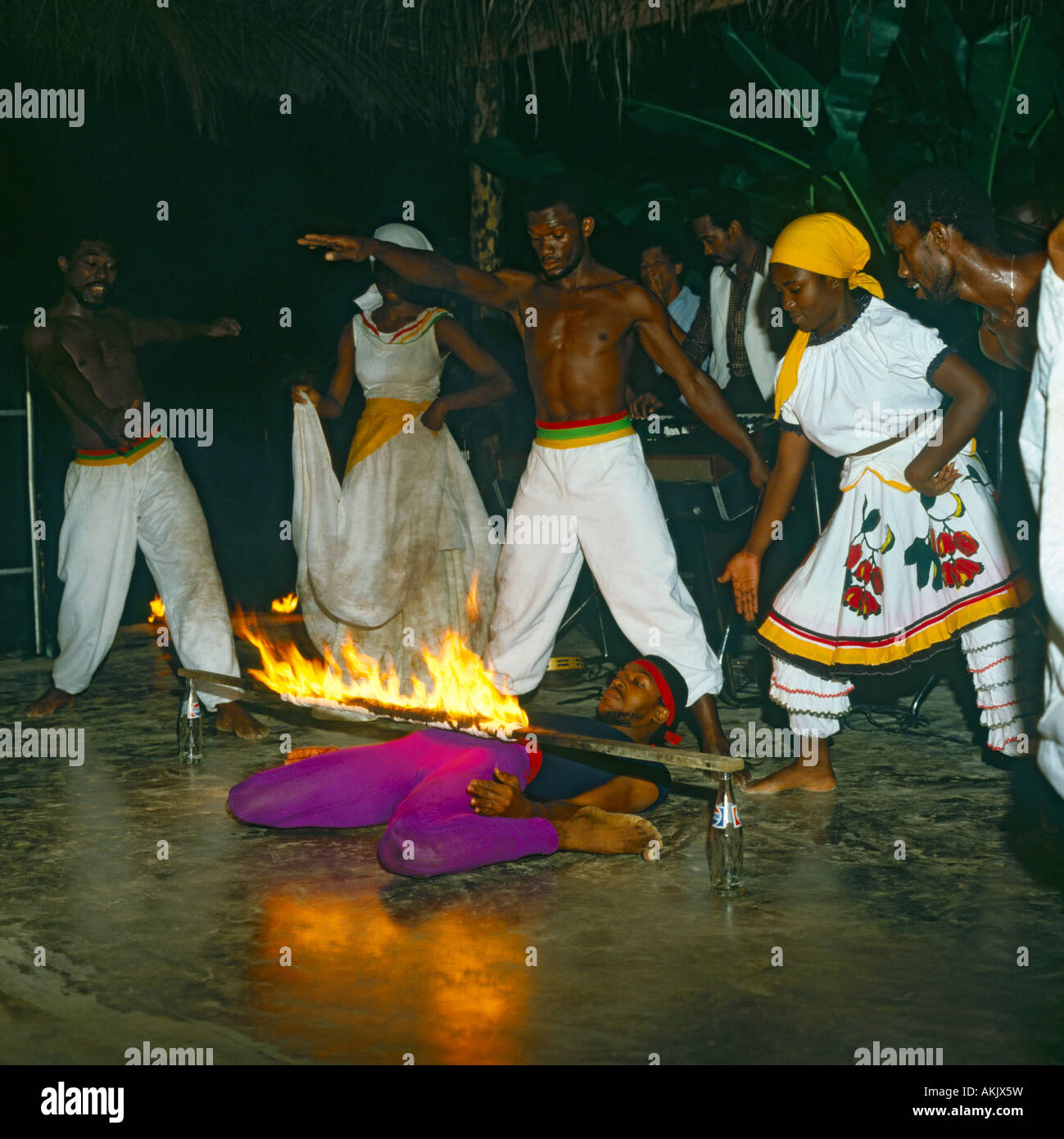 Local man does limbo dance wriggling below very low flaming bar ...