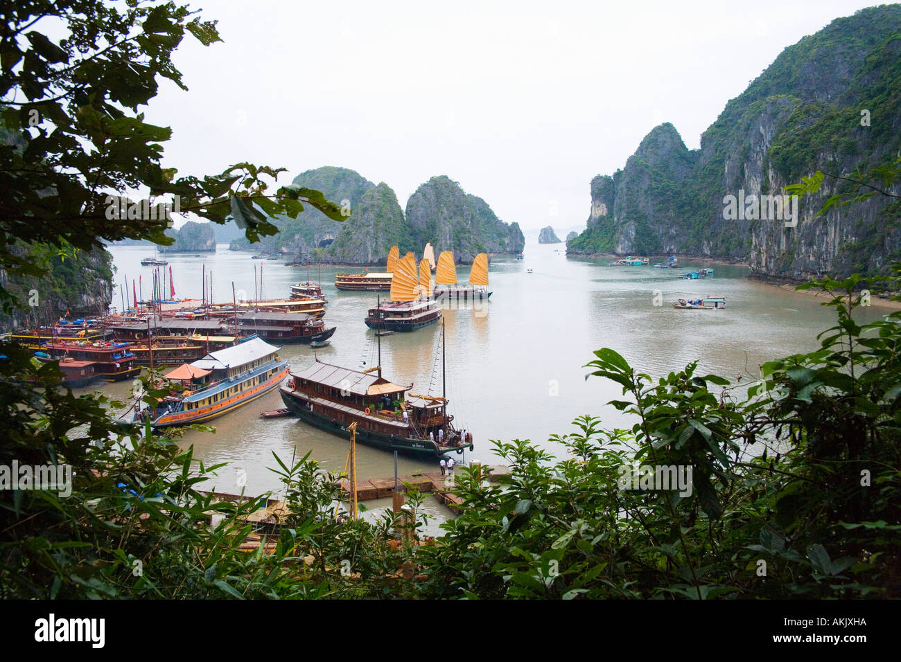 Boats and rocky islands in Vietnamese harbor Stock Photo - Alamy