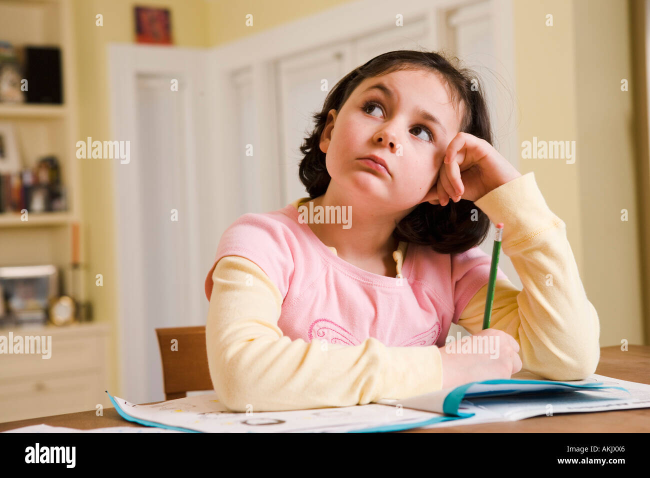 Grade school girl doing homework Stock Photo - Alamy