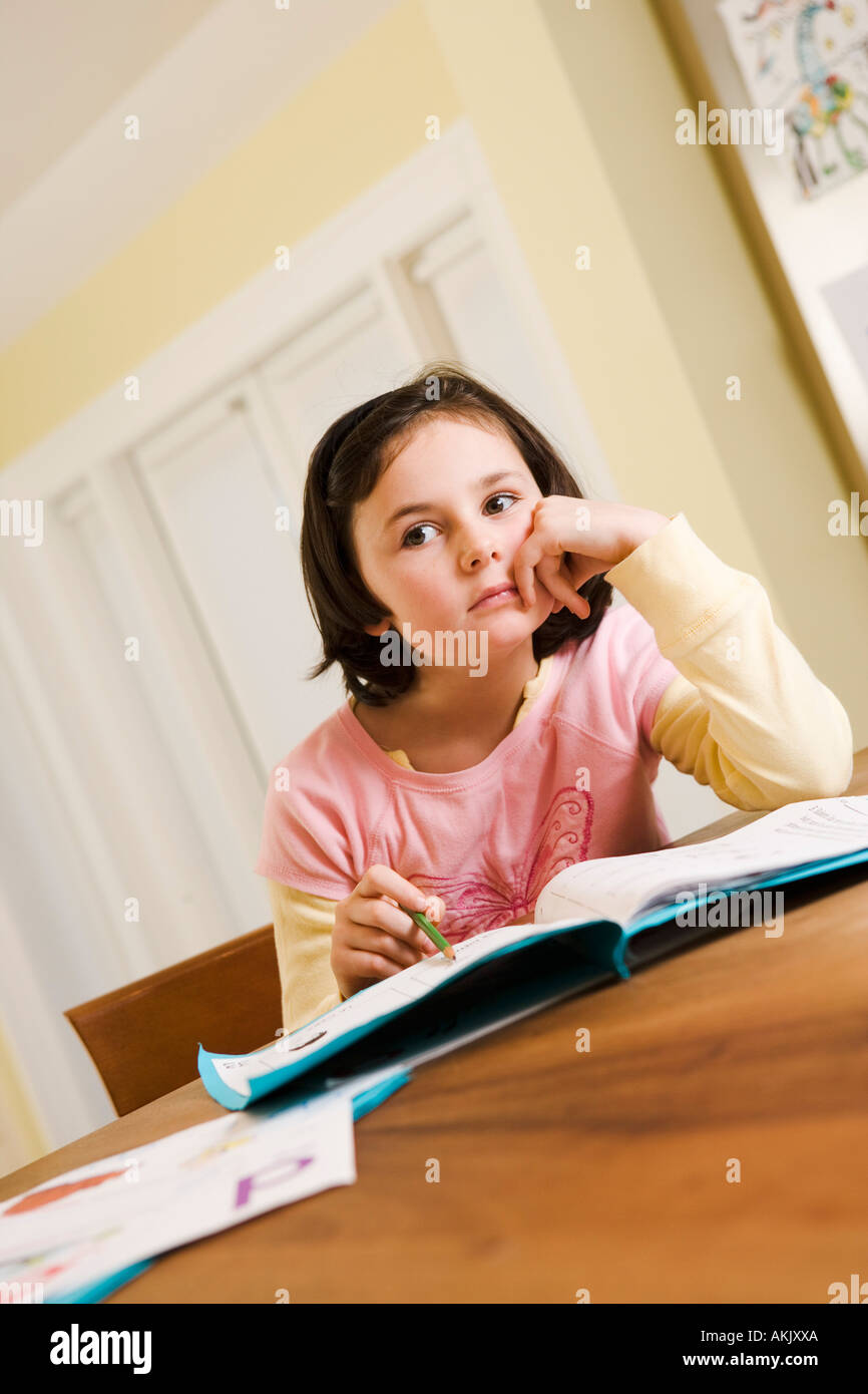 Grade school girl distracted from homework Stock Photo - Alamy
