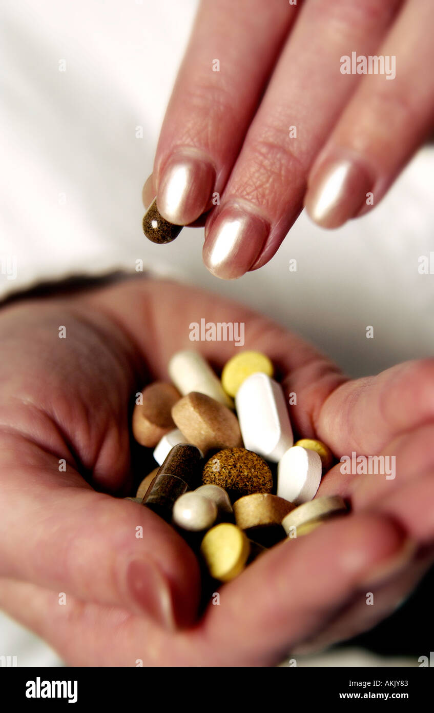 Woman taking pills Stock Photo - Alamy