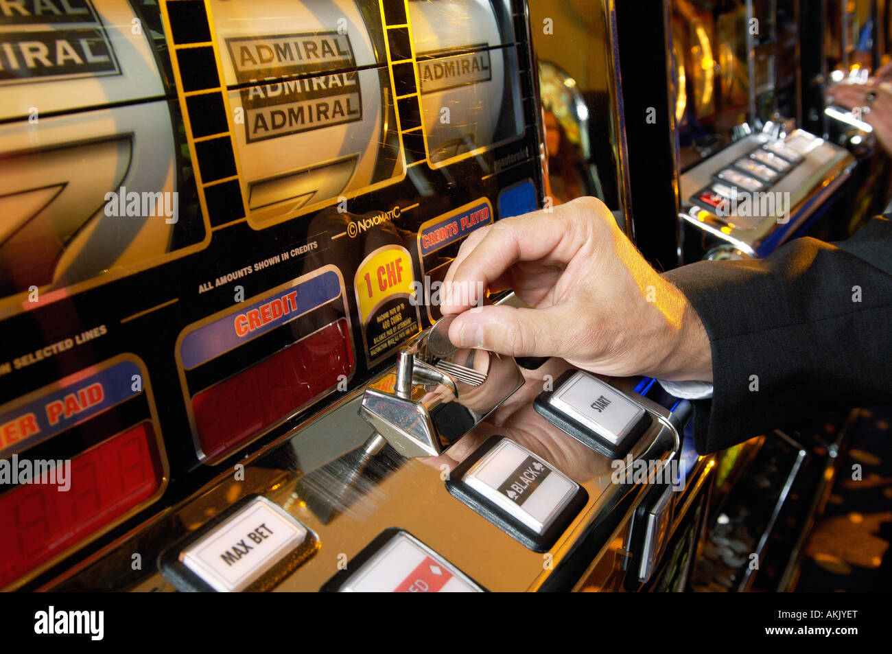man playing on a slot machine Stock Photo - Alamy