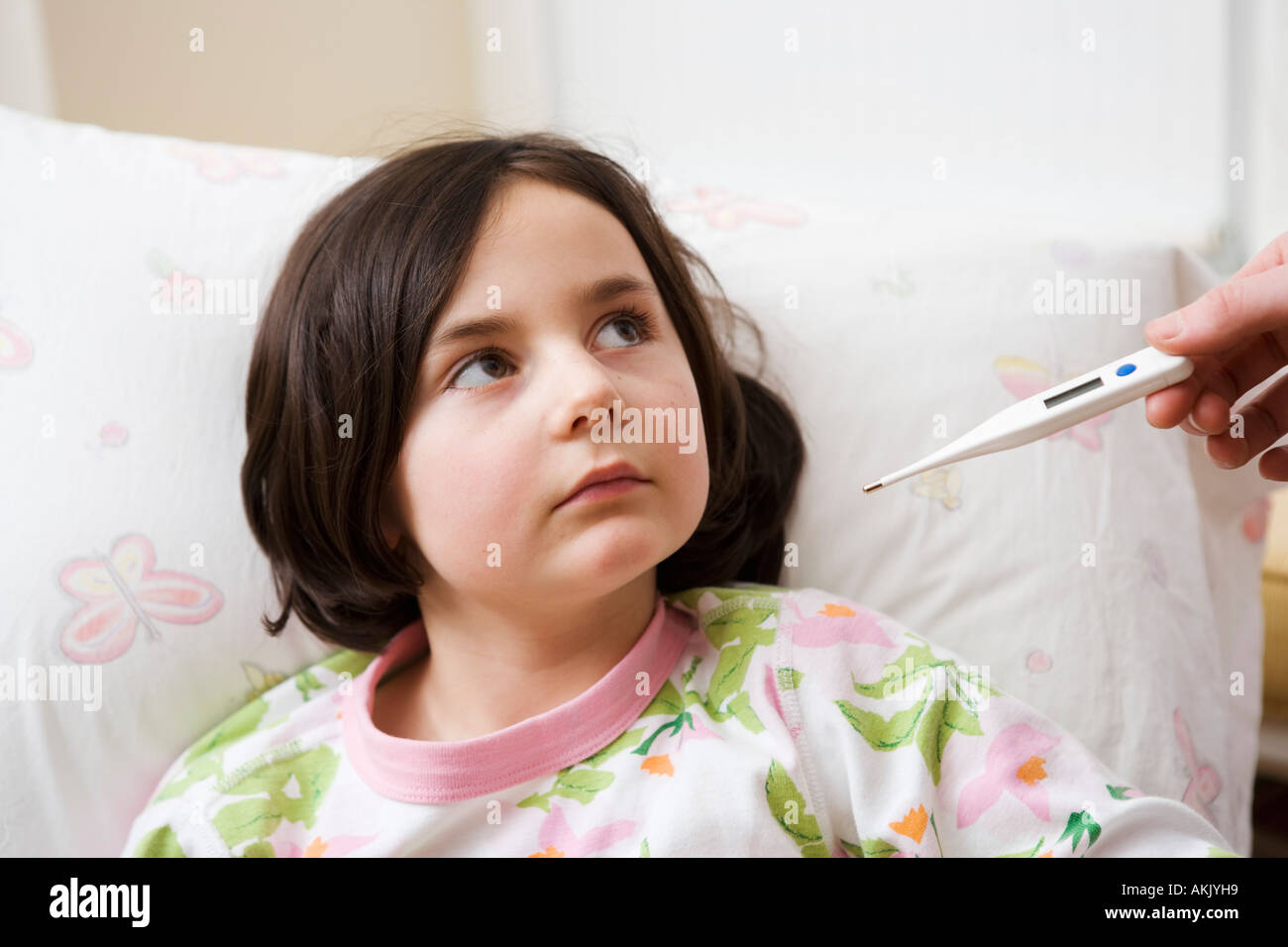 Young girl having temperature taken Stock Photo - Alamy