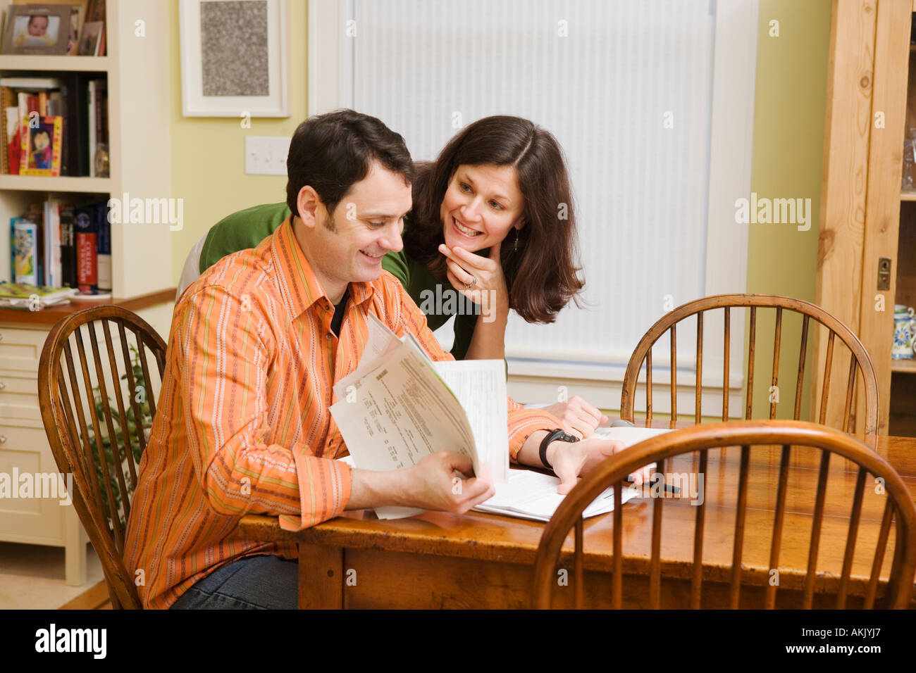 Couple leaning papers table hi-res stock photography and images - Alamy