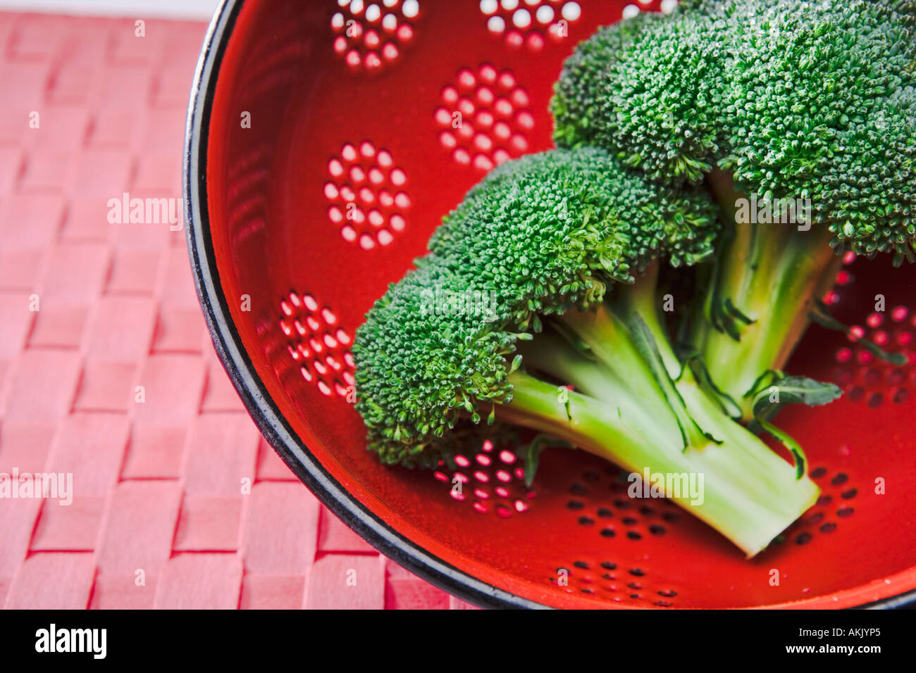 Broccoli crowns in red colander Stock Photo - Alamy