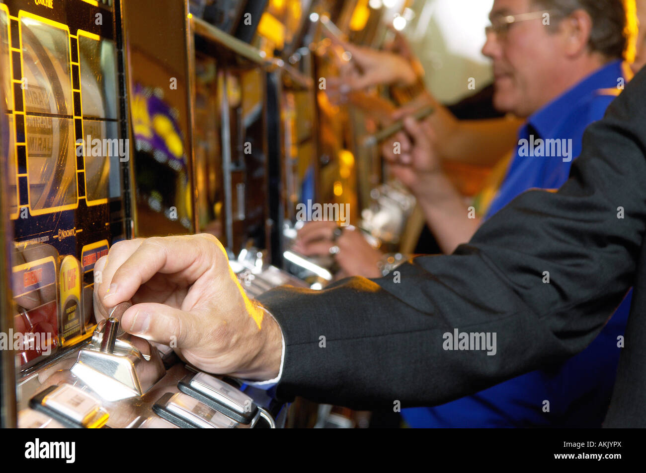 man playing on a slot machine Stock Photo - Alamy