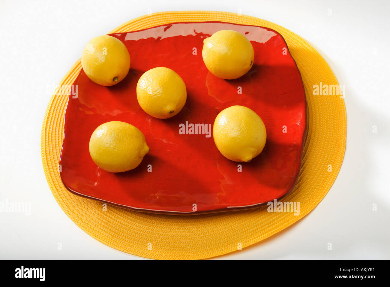 Five lemons on red platter Stock Photo - Alamy