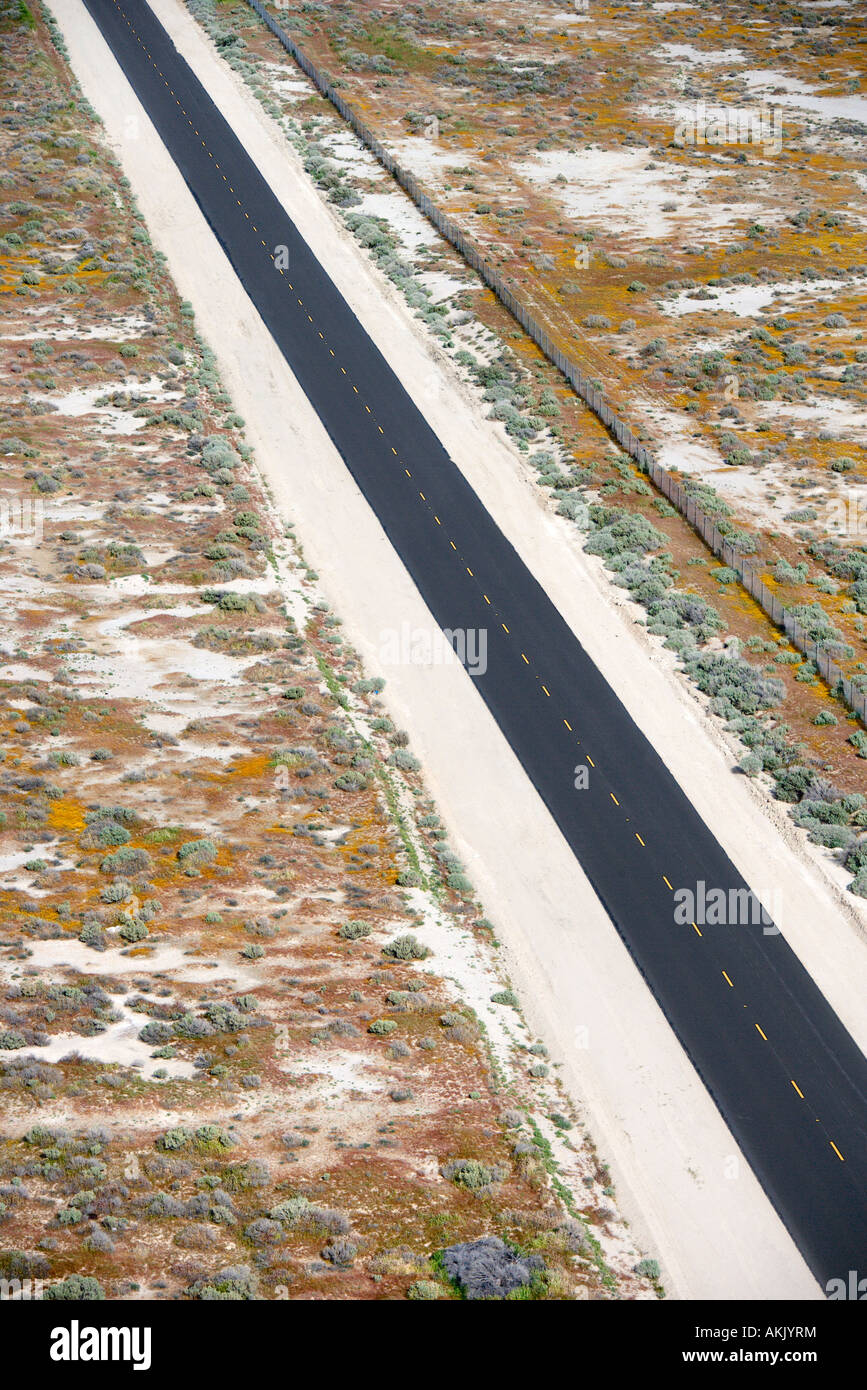 Aerial of two lane highway through desolate landscape Stock Photo - Alamy