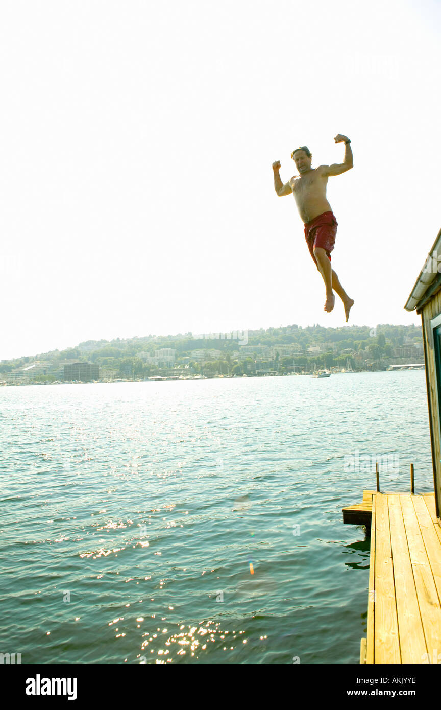 Man in swim trunks jumping hi-res stock photography and images - Alamy