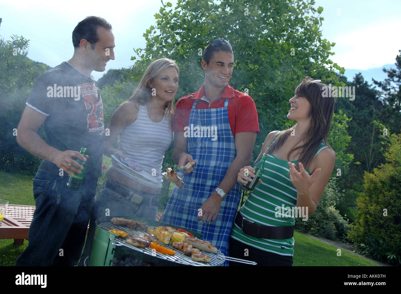 young people having a barbecue Stock Photo - Alamy